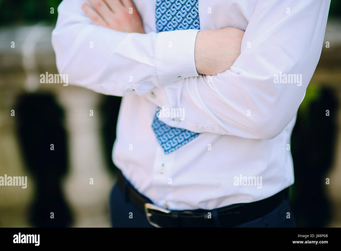 Male hands crossed on chest. Hands of the groom on the chest Stock ...