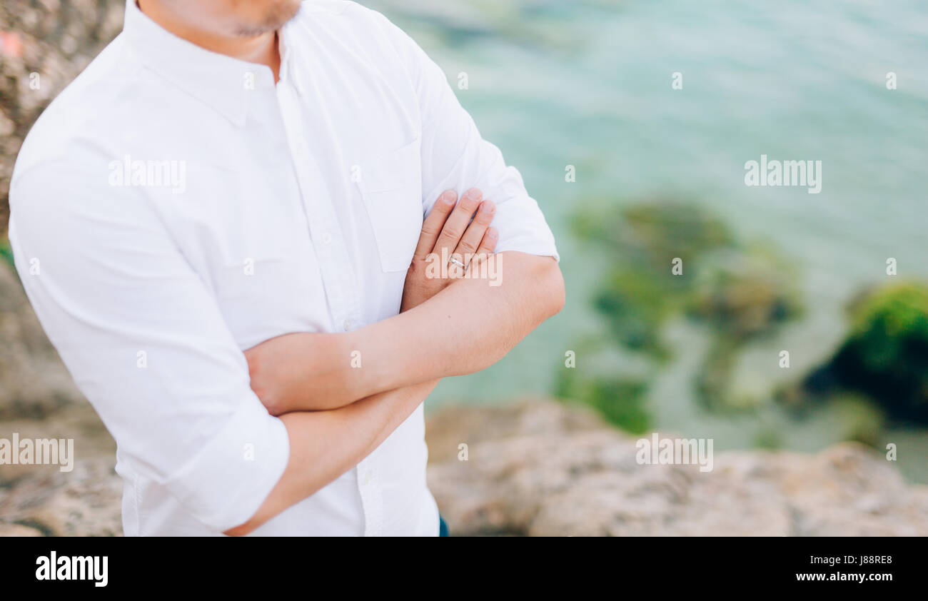 Male hands crossed on chest. Hands of the groom on the chest Stock ...