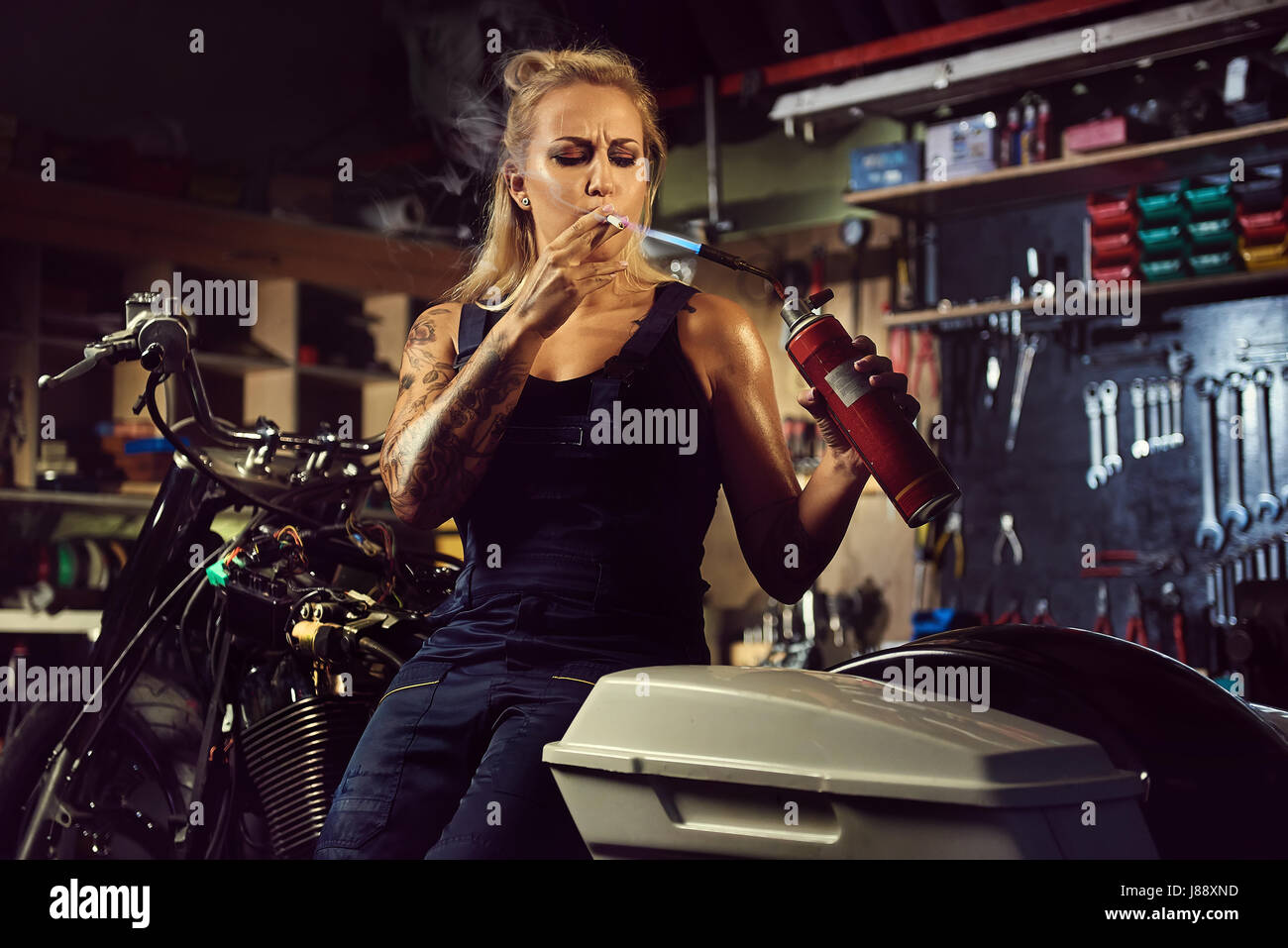 Blond female smoking cigarette hi-res stock photography and images - Alamy