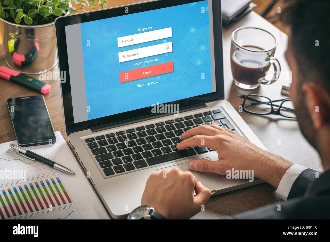 Young man in his office - login on the laptop screen Stock Photo - Alamy