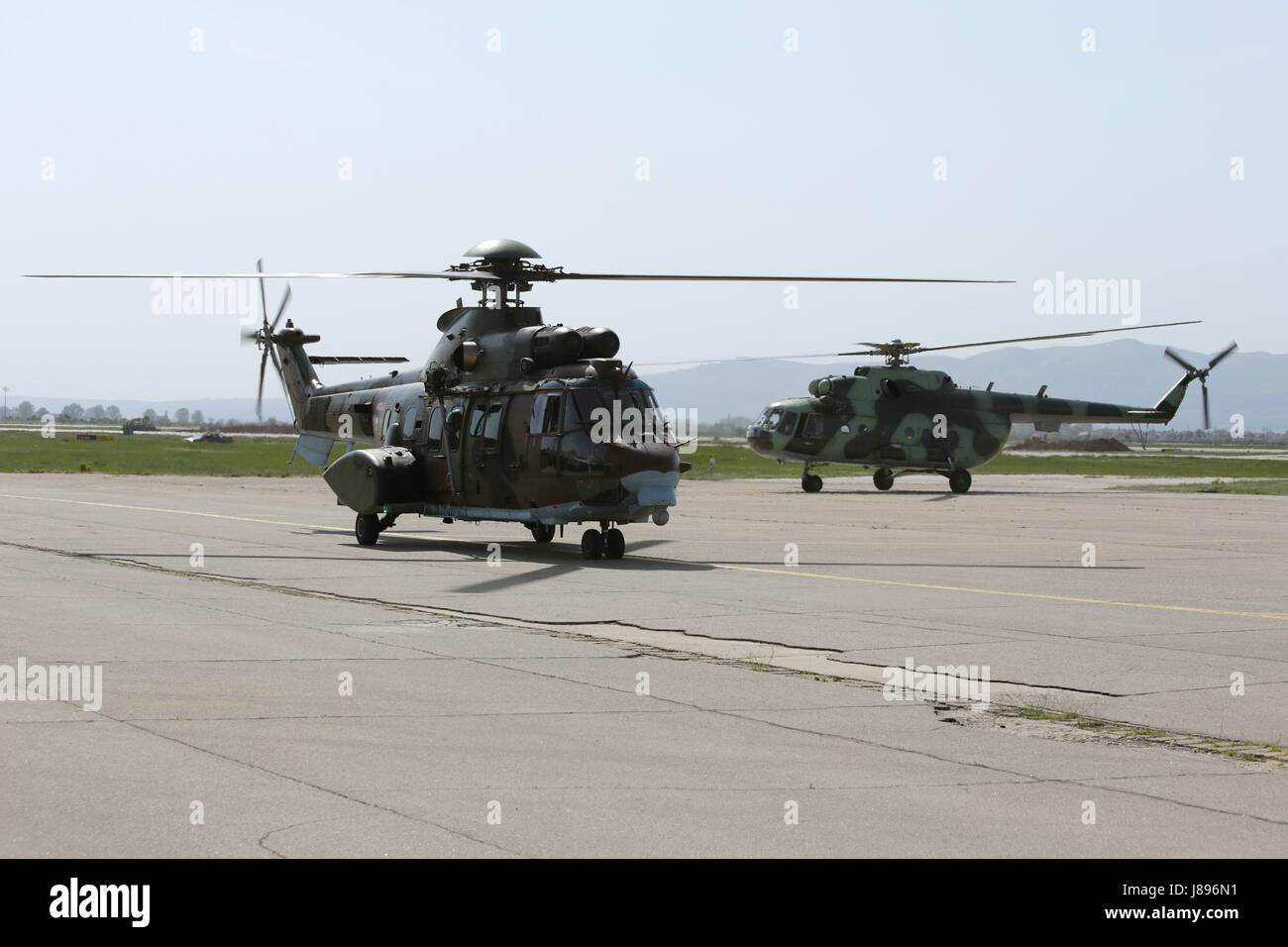 Military helicopters at the runway of the airport Stock Photo - Alamy