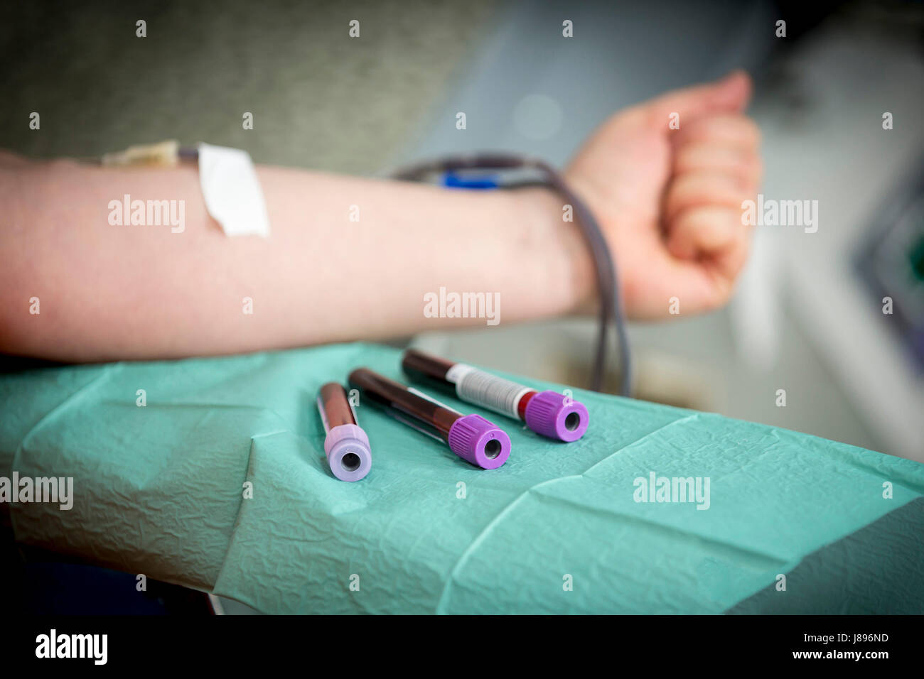 The hand of a woman who donates blood. Female donor gives blood in a ...