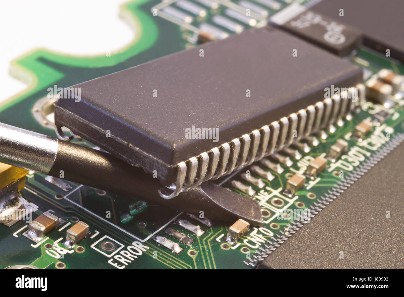 removing computer chip Stock Photo - Alamy