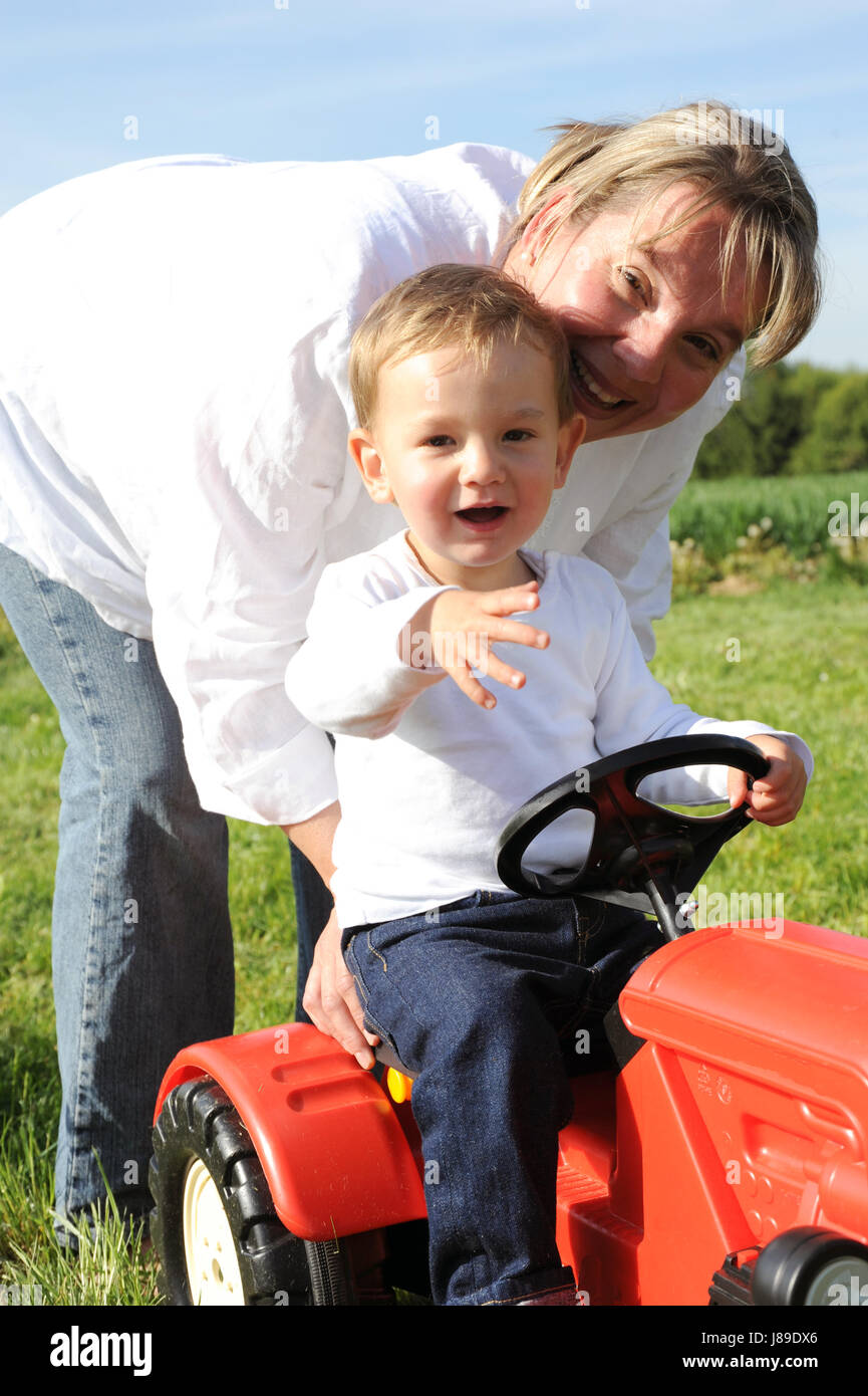 mother and son with red tractor Stock Photo - Alamy