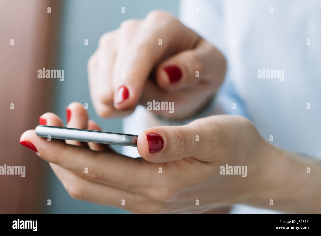 Women holding smartphone and touching screen Stock Photo - Alamy