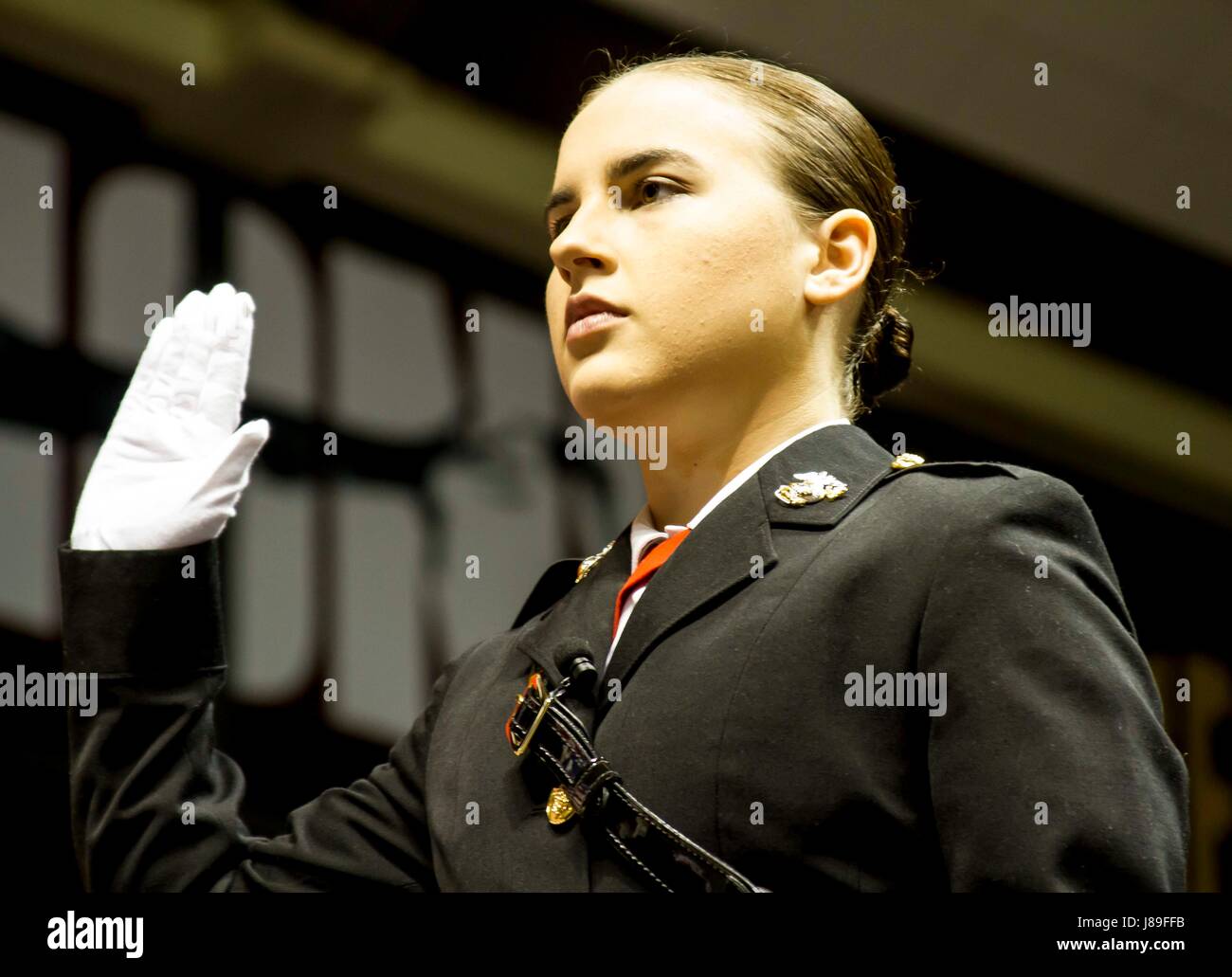 Mary Sanders raises her hand and takes the Oath of Office in order to ...