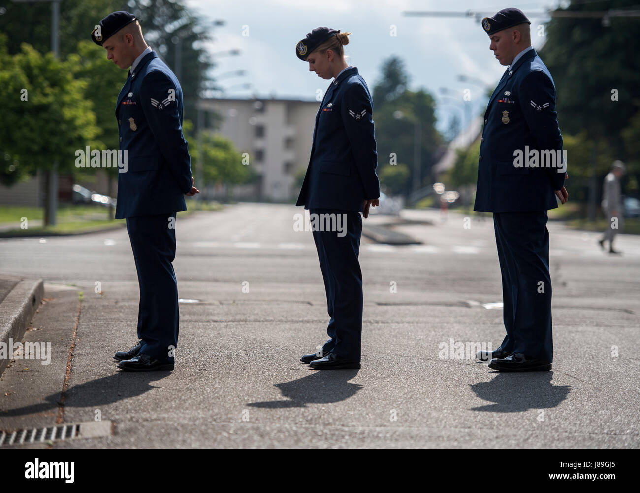 374th Security Forces Squadron members bow their heads in prayer during ...