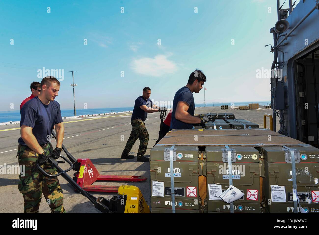 EARLE, N.J. (May 18, 2017) – Sailors load ammunition into a flight deck ...