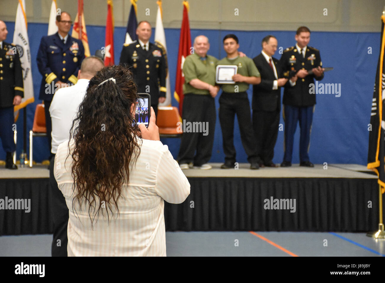 A proud future U.S. Army Reserve mom takes photos as her son receives ...
