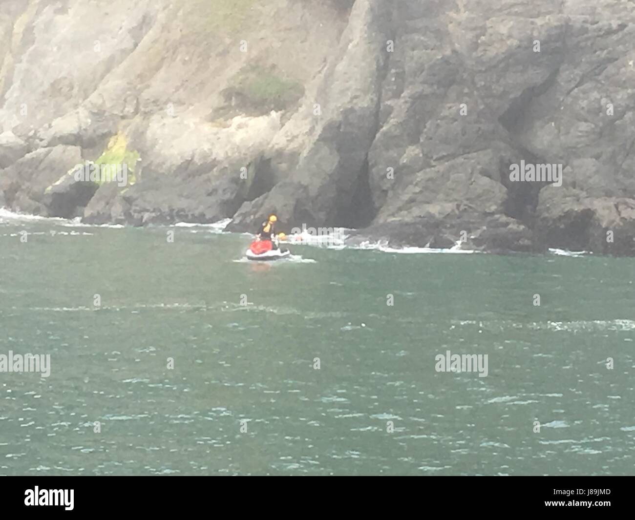 San Francisco Fire Department members aboard a jet ski assist a ...
