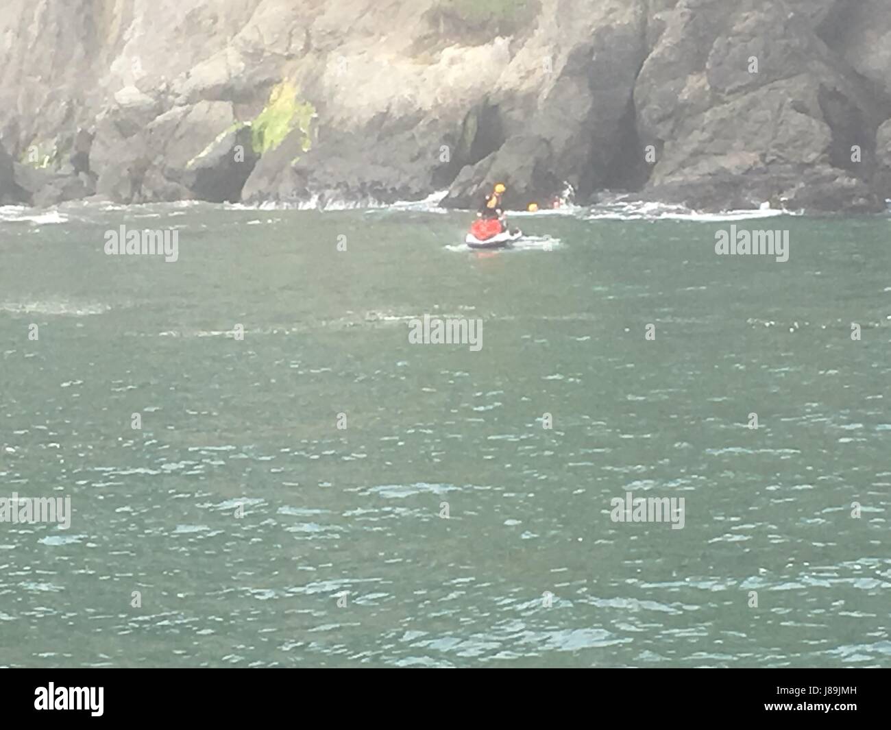 San Francisco Fire Department members aboard a jet ski assist a ...