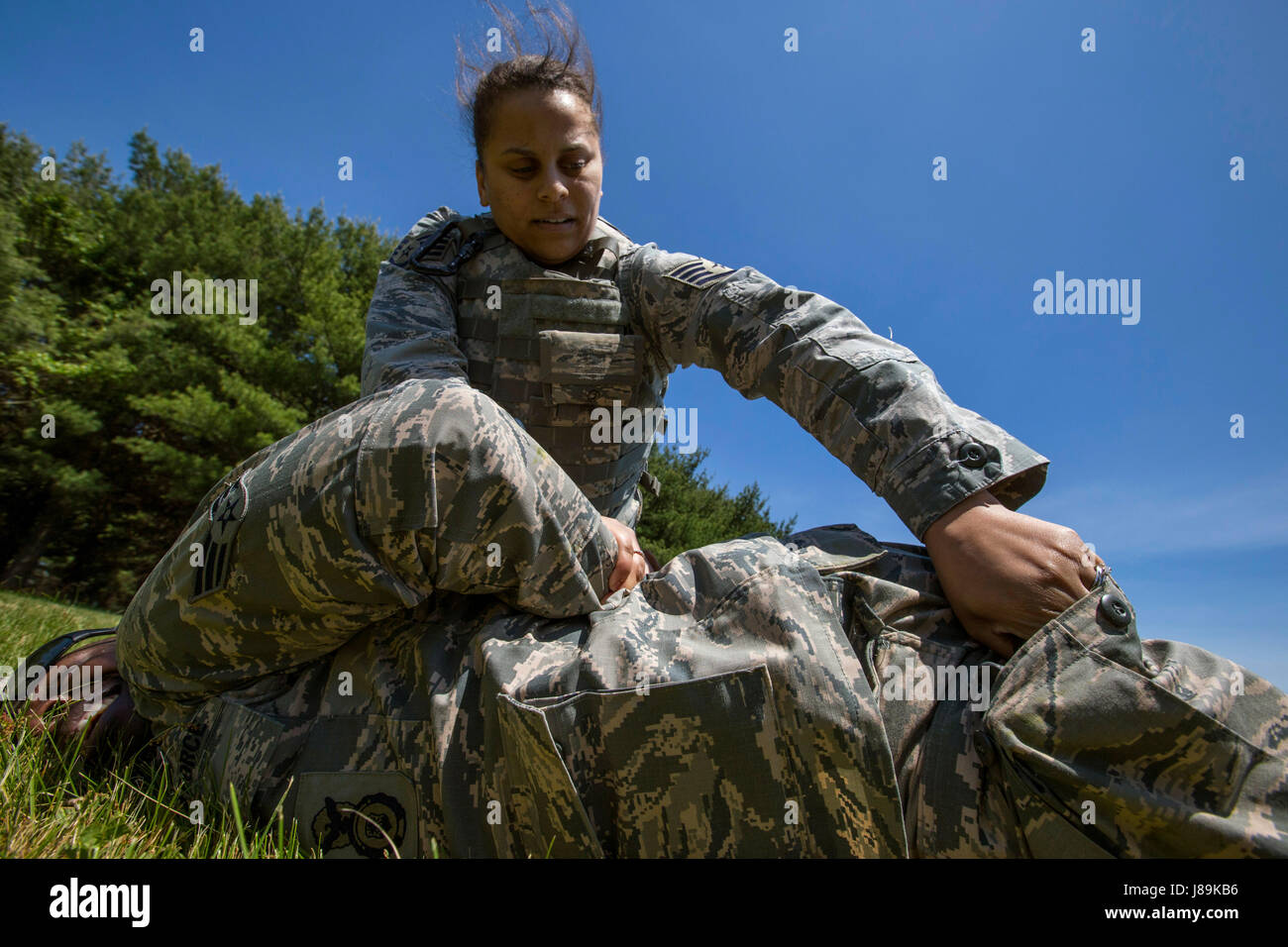 U.S. Air Force Staff Sgt. Angel N. Christiansen, top, handcuffs Senior ...