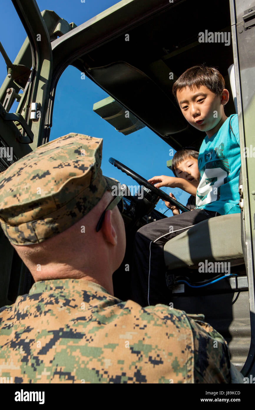 A child asks U.S. Marine Lance Cpl. Trevor Stan, a fire direction ...