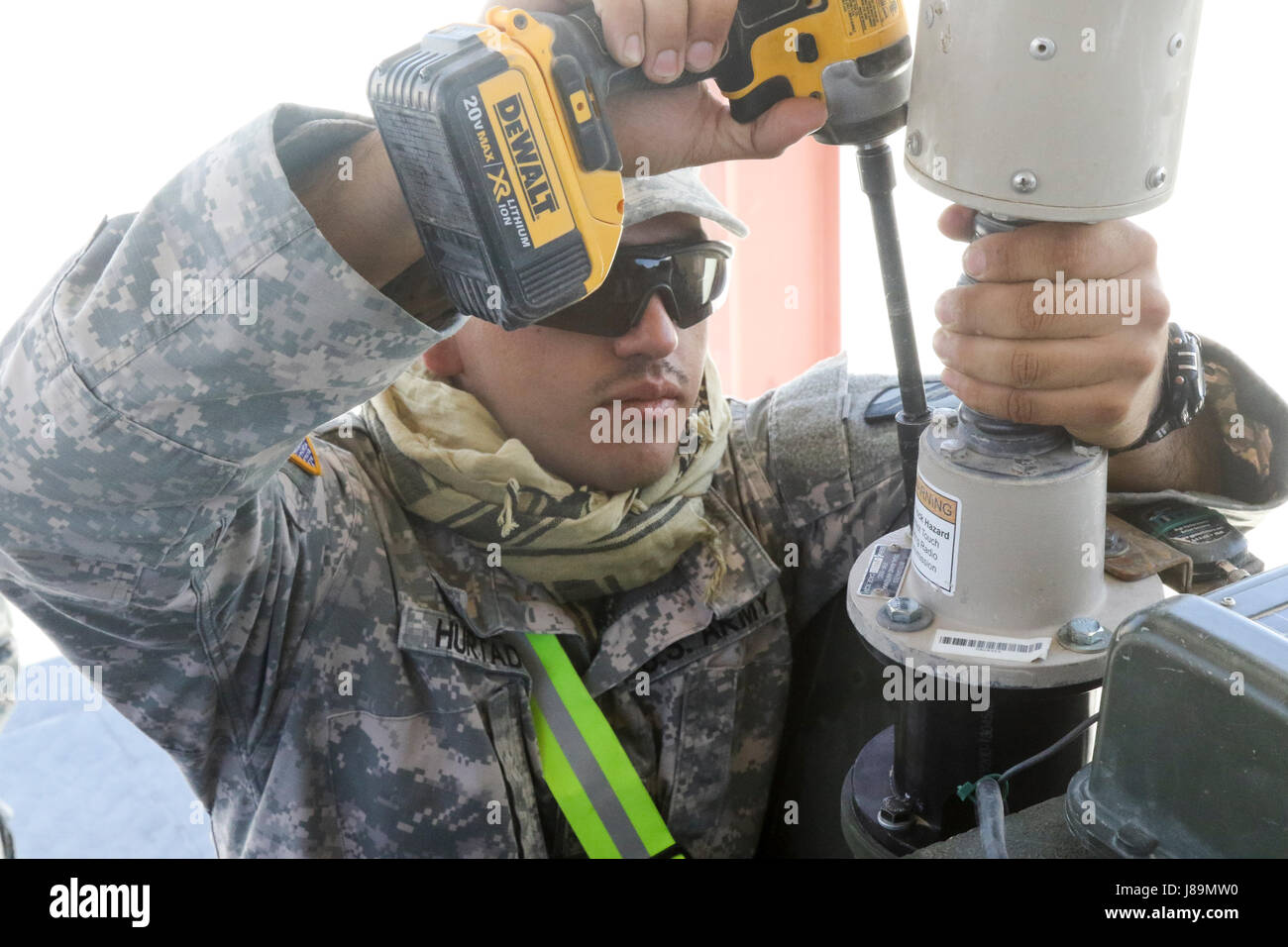 Electronic warfare specialists install a Duke system antenna on a ...