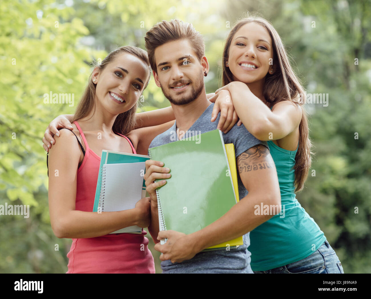 Back to school, group of young students and friends posing at the park ...