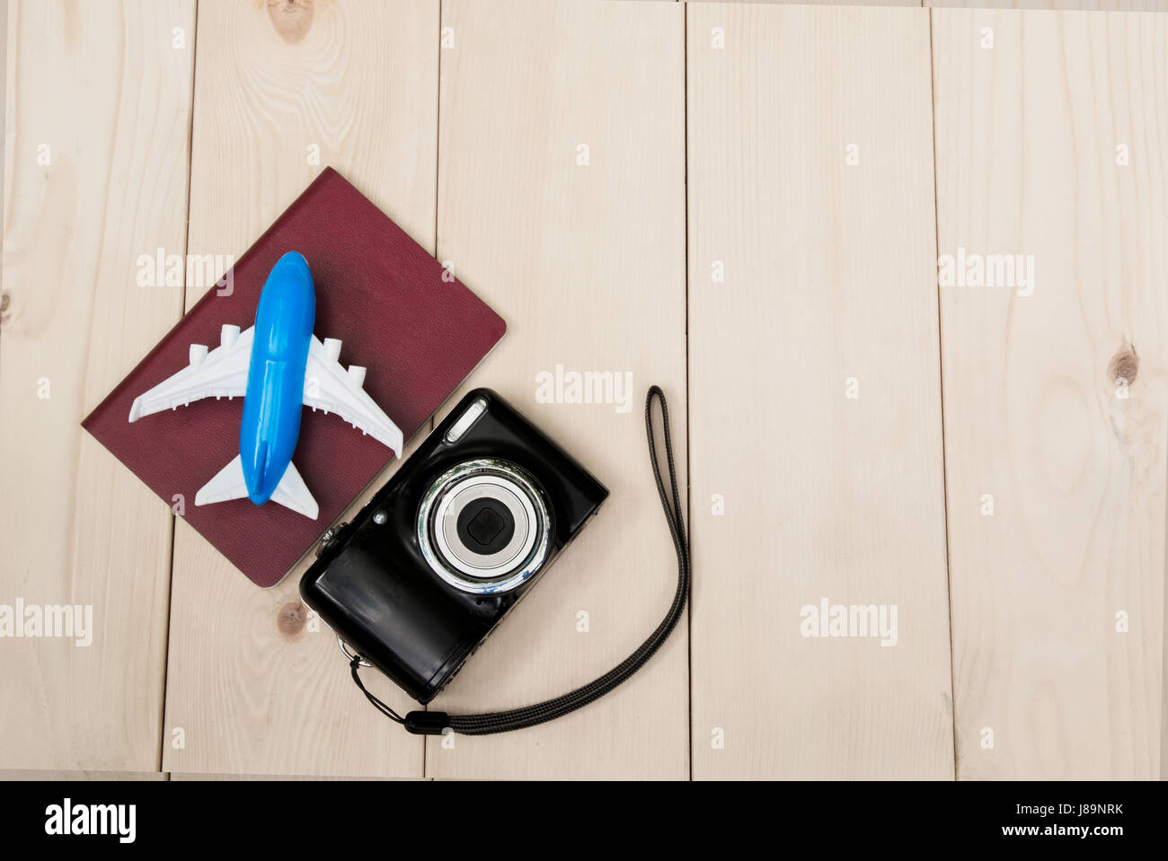 Camera with air plane and notebook for travel wooden table background ...