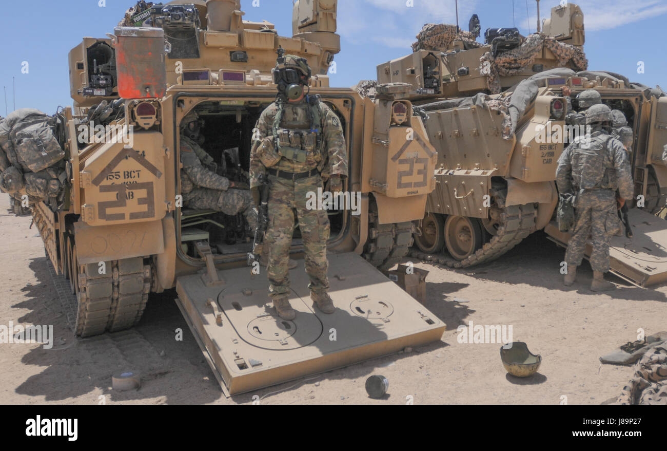 Dressed in combat gear and gas mask, a 2d Battalion, 198th Armored ...