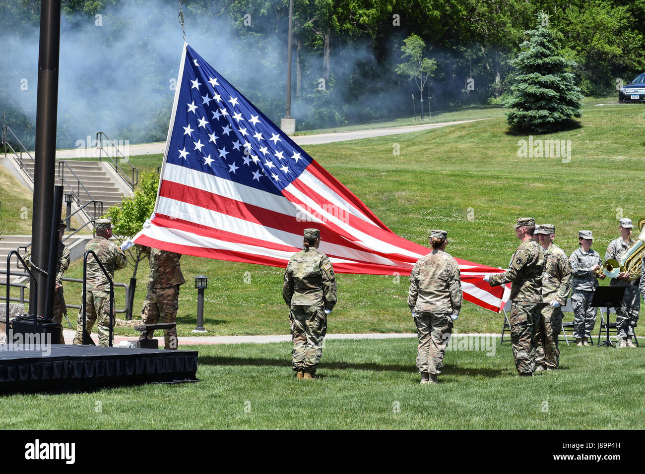 Members of the Iowa National Guard lower the flag while conducting ...