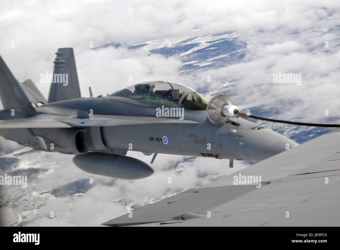 A Finnish Air Force F/A-18 Hornet conducts an aerial refueling mission ...