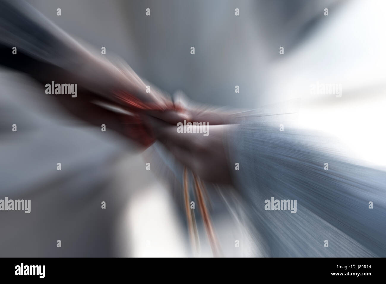 Human hands holding each other. shot with motion blur Stock Photo - Alamy