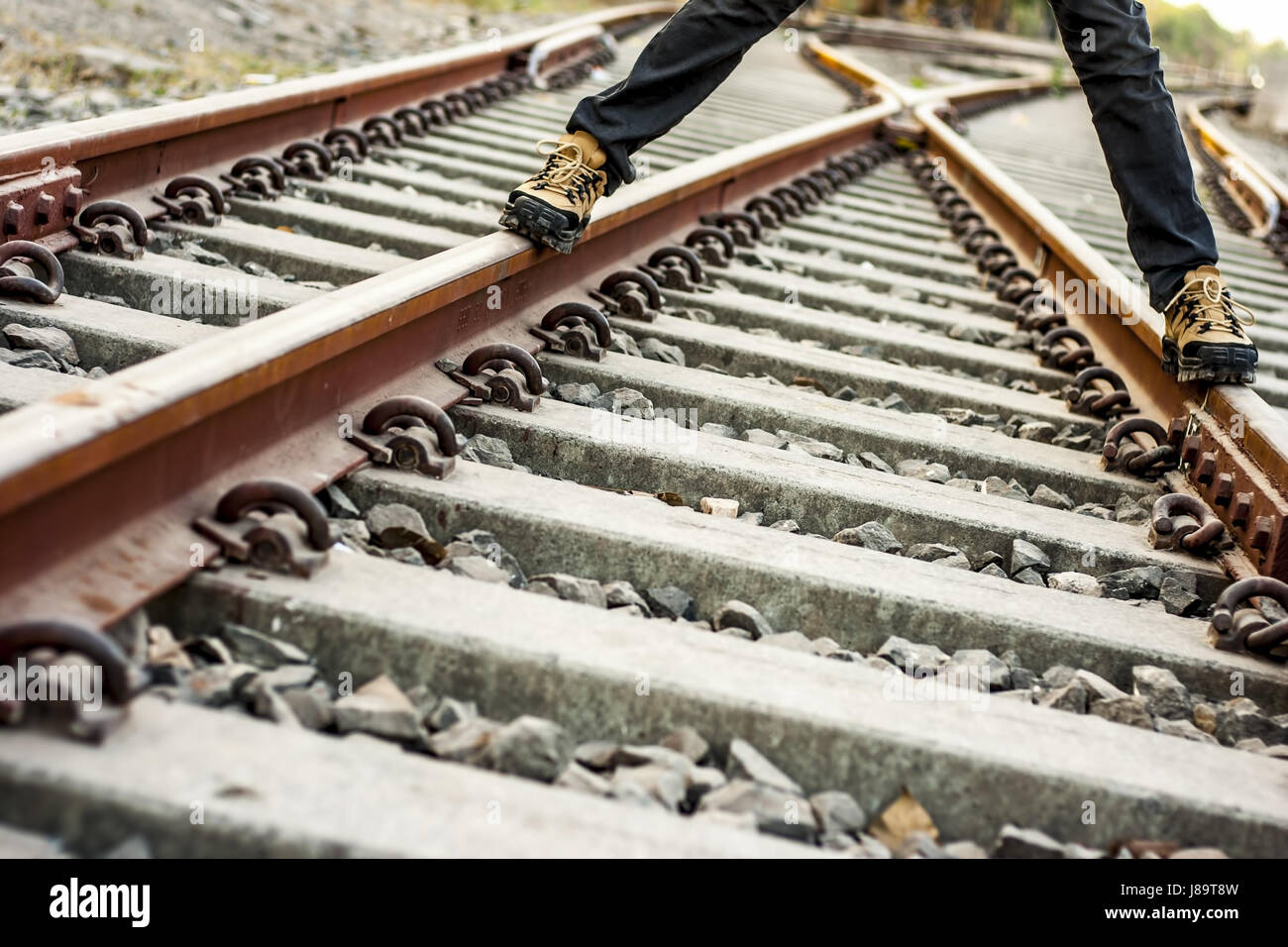 A boy standing on railway tracks wearing leather shoes Stock Photo - Alamy