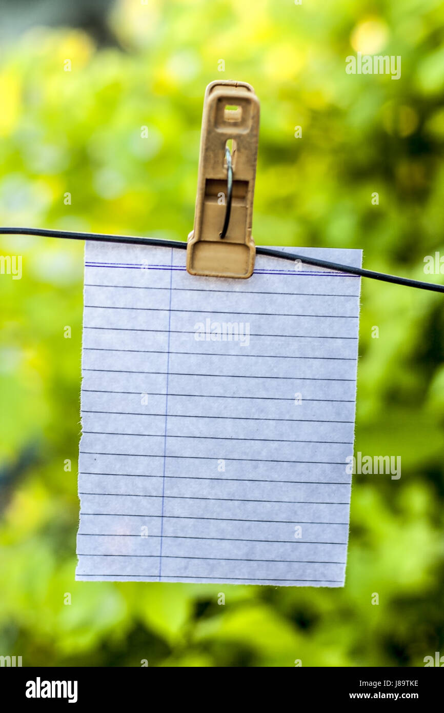 Note book paper hanging on the washing line Stock Photo - Alamy