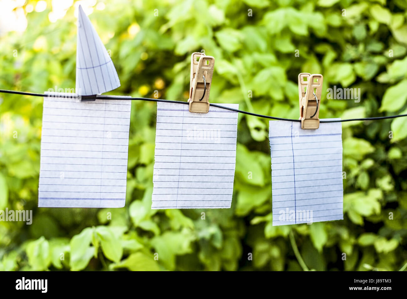 Note book paper hanging on the washing line Stock Photo - Alamy