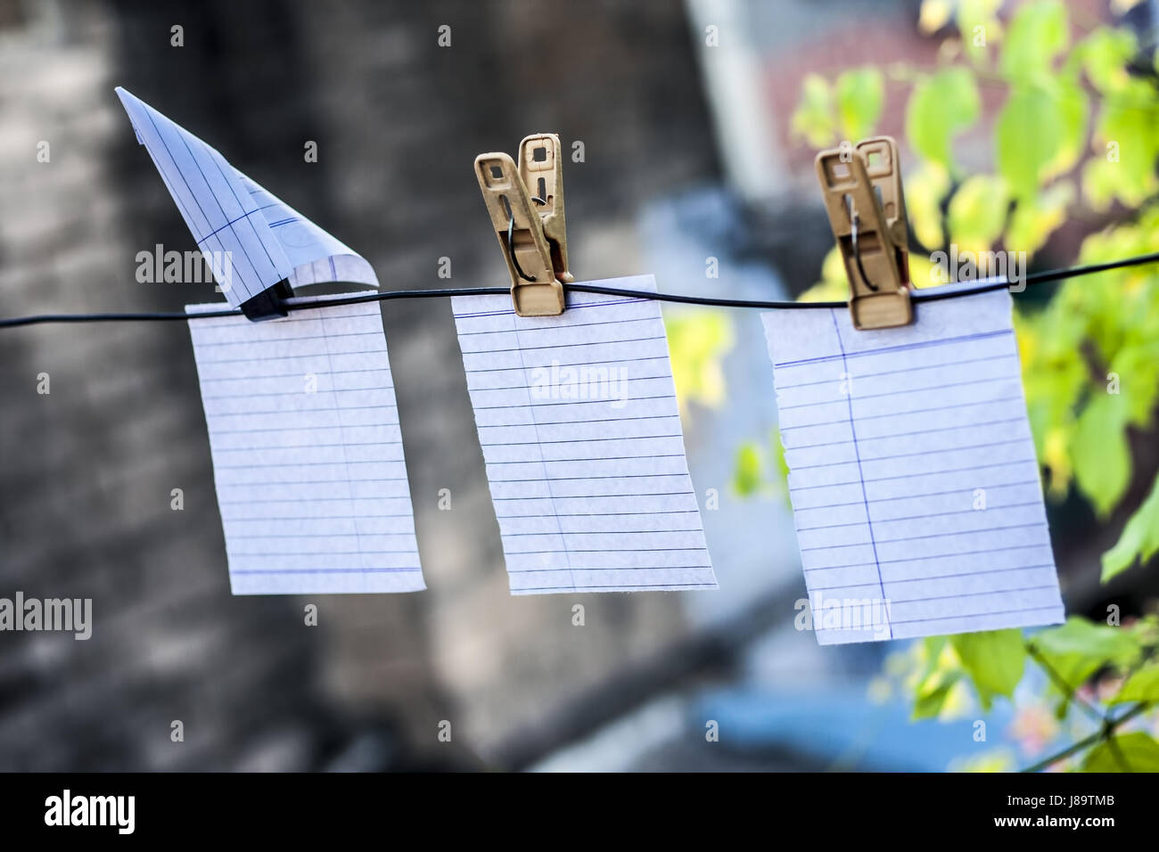 Note book paper hanging on the washing line Stock Photo - Alamy