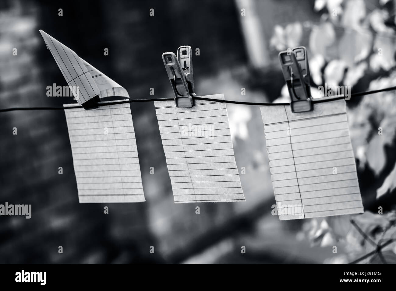 Note book paper hanging on the washing line Stock Photo - Alamy
