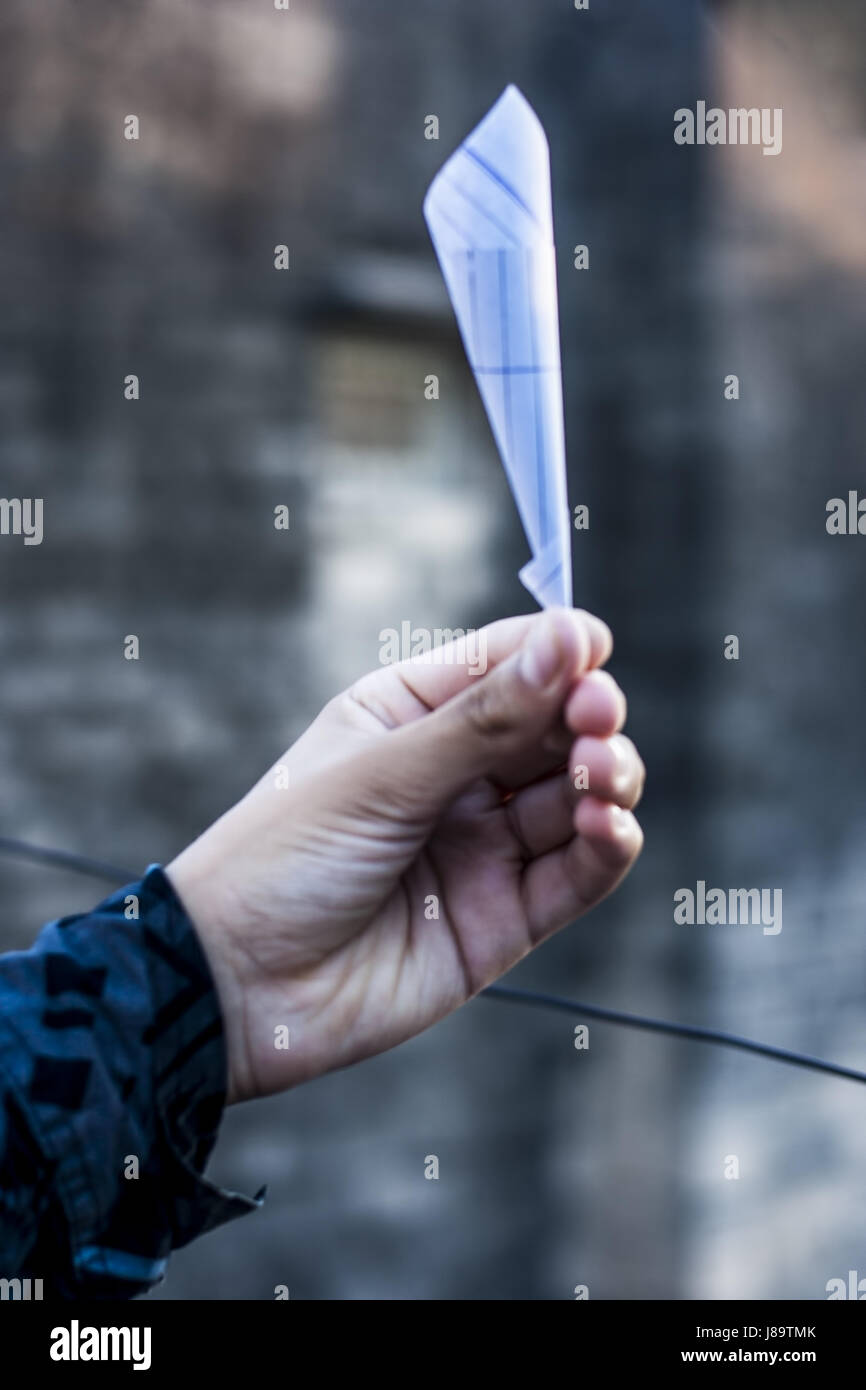 Simple paper role in a human hand Stock Photo - Alamy