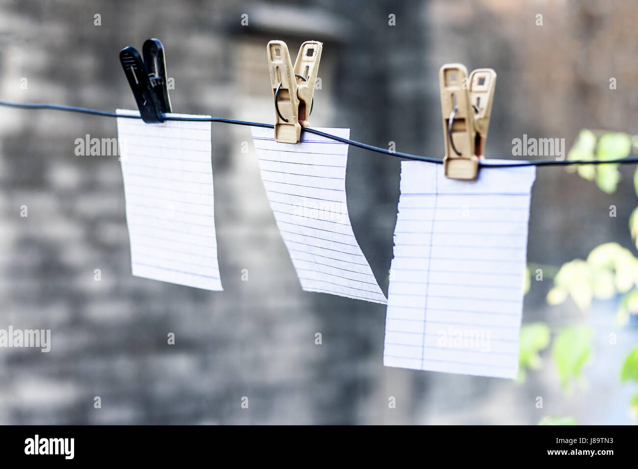 Note book paper hanging on the washing line Stock Photo - Alamy
