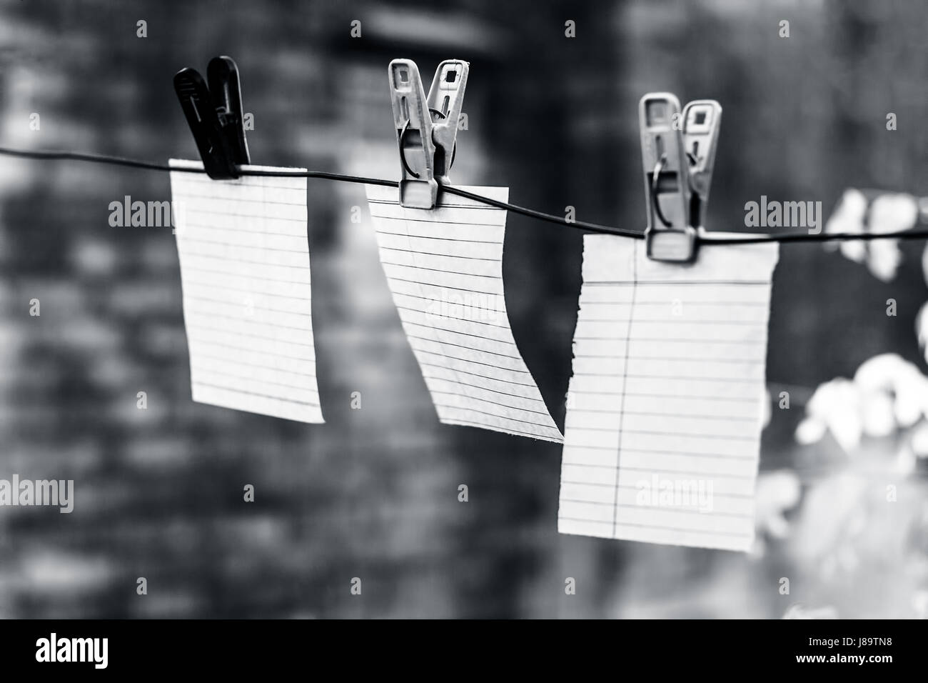 Note book paper hanging on the washing line Stock Photo - Alamy