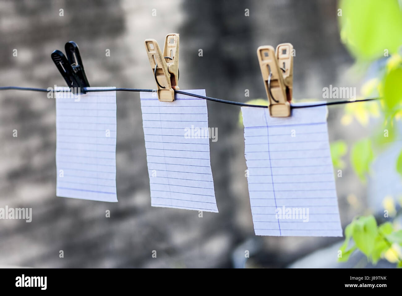 Note book paper hanging on the washing line Stock Photo - Alamy