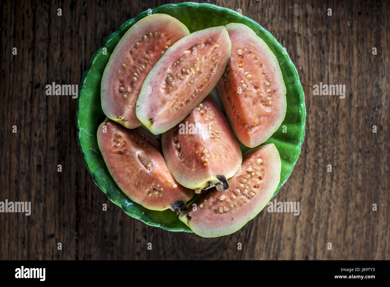 Raw organic cut guava on a plate Stock Photo - Alamy