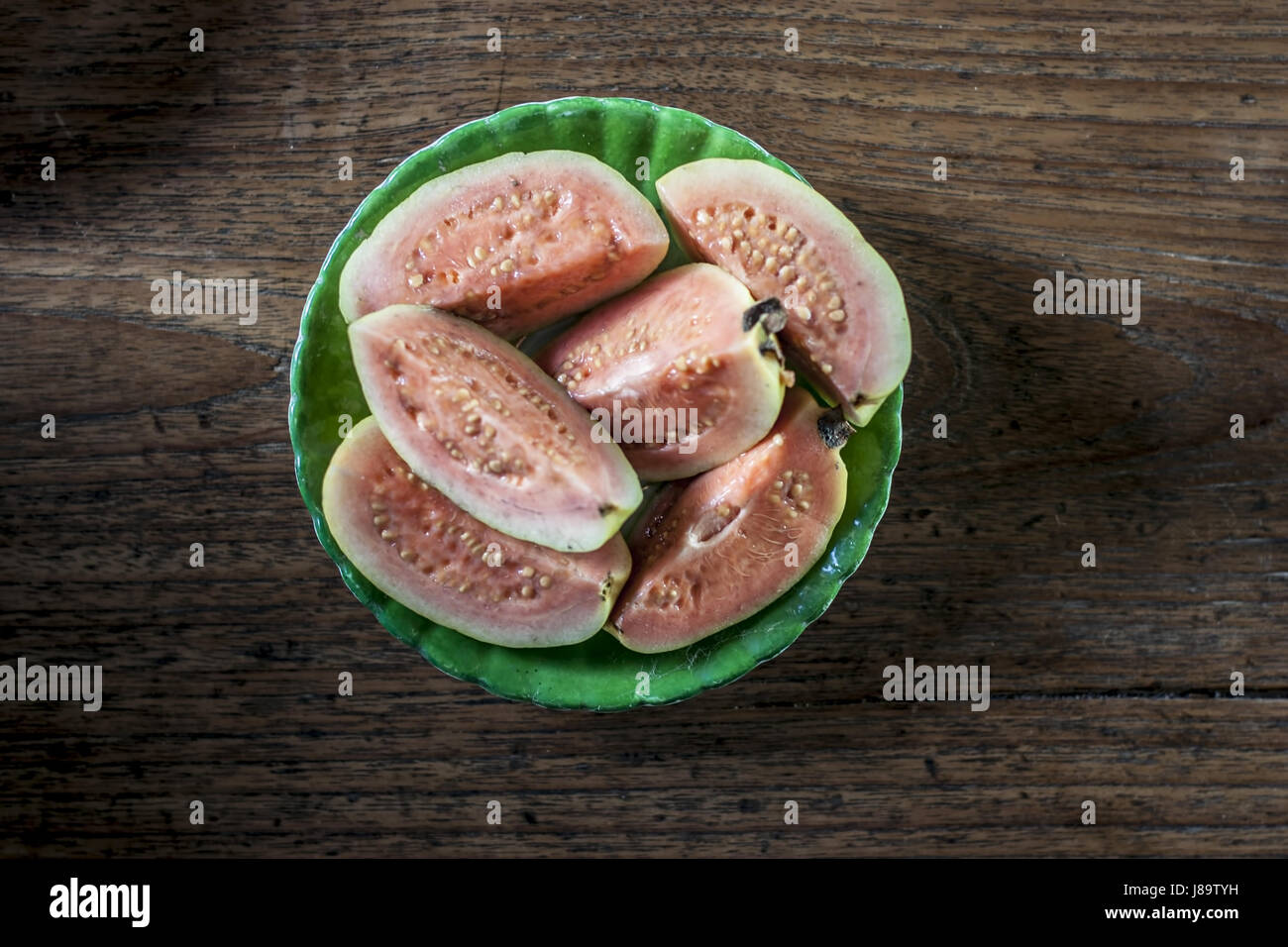 Raw organic cut guava on a plate Stock Photo - Alamy