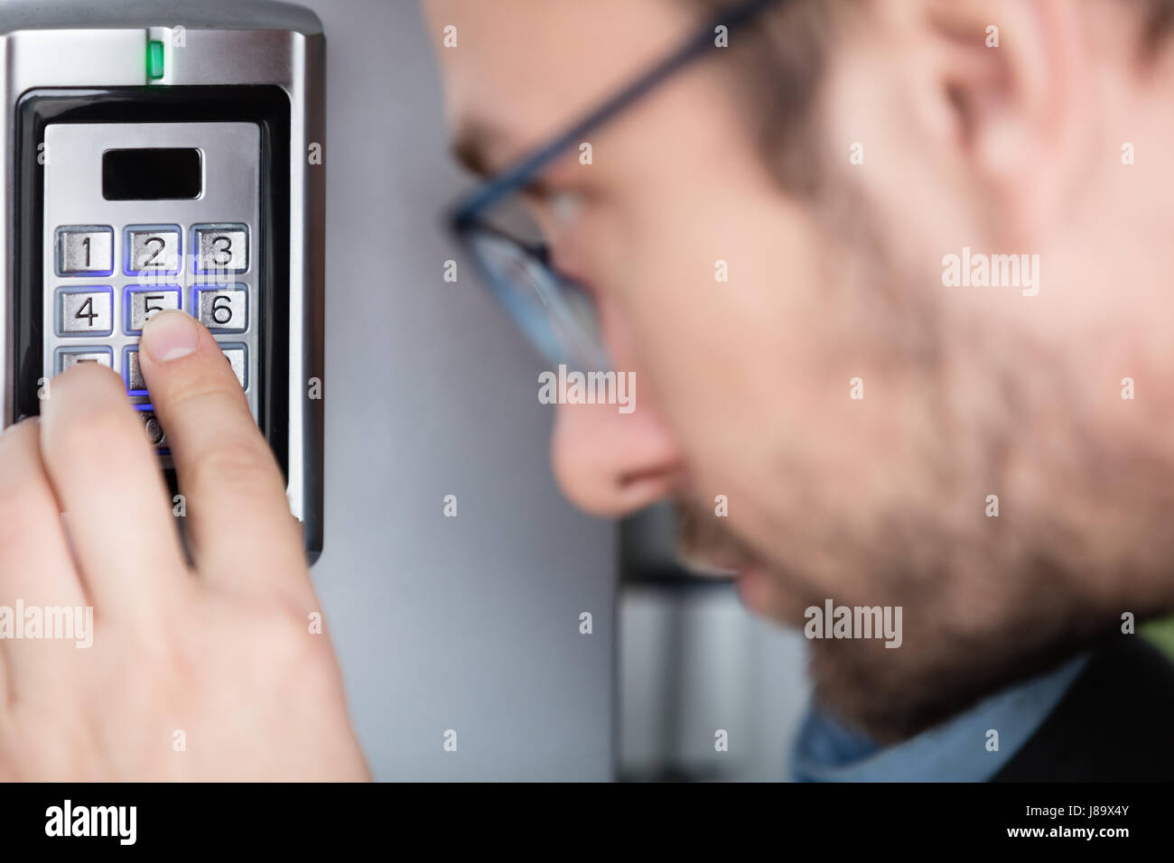 Close up of a man entering security code combination to unlock the door ...