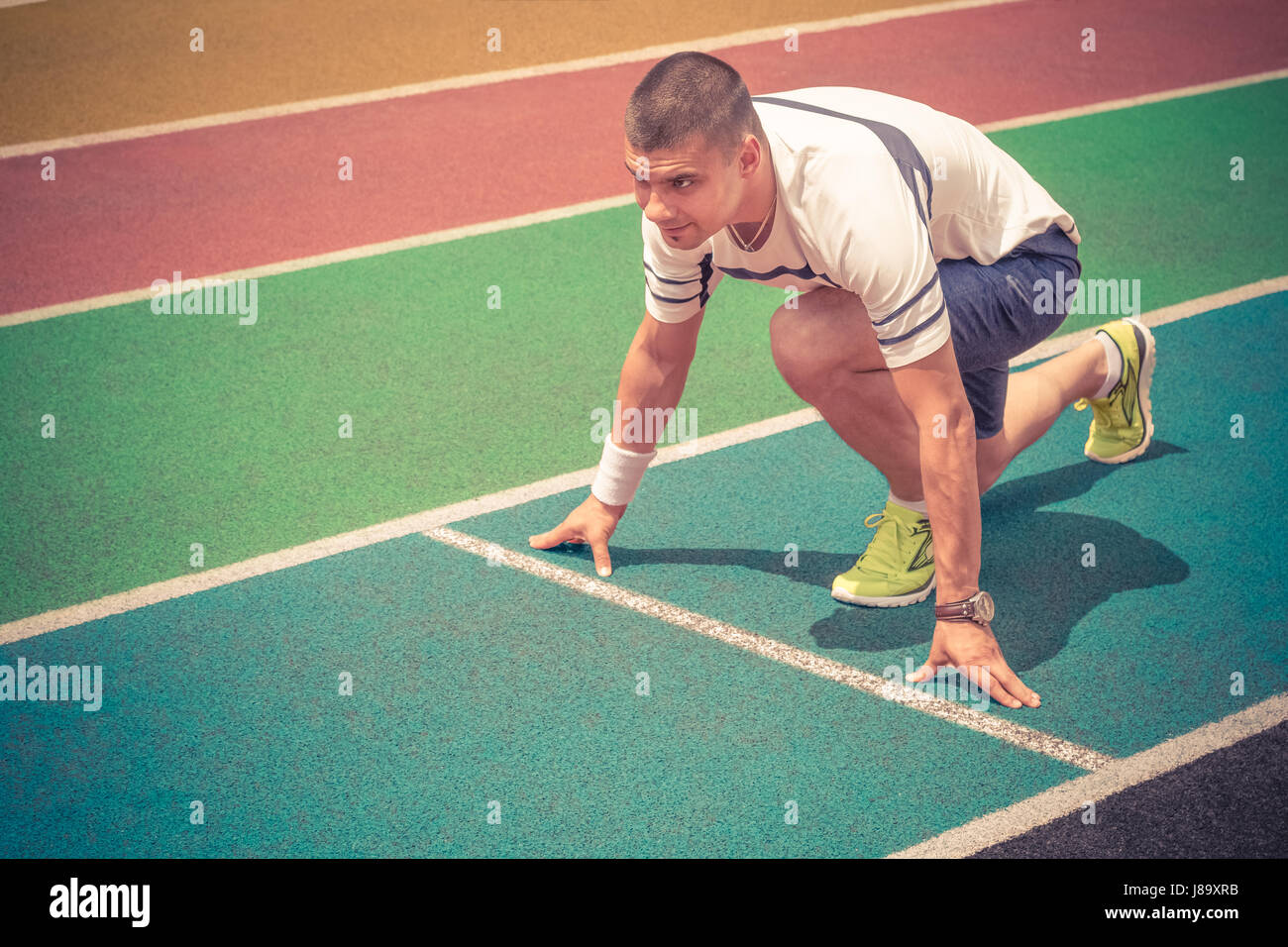 Male sprinter in blocks hi-res stock photography and images - Alamy