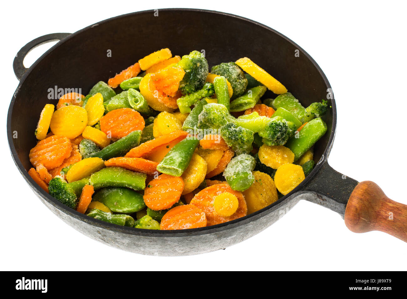 Frozen vegetables in cast-iron frying pan Stock Photo - Alamy
