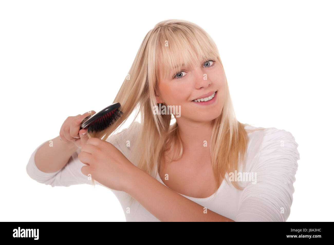 young woman combing her hair Stock Photo - Alamy