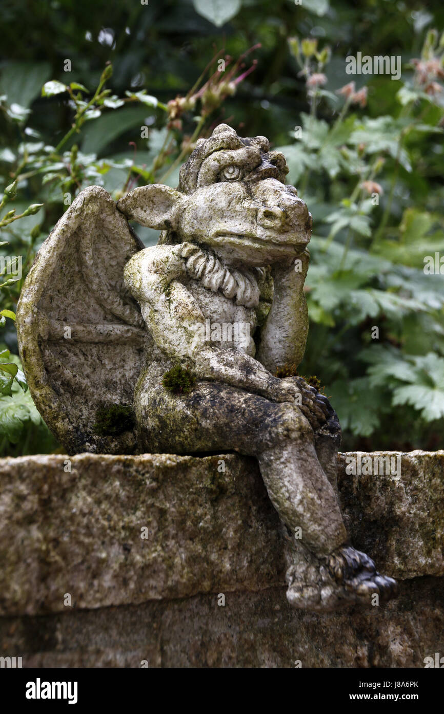gargoyle on a garden wall Stock Photo - Alamy