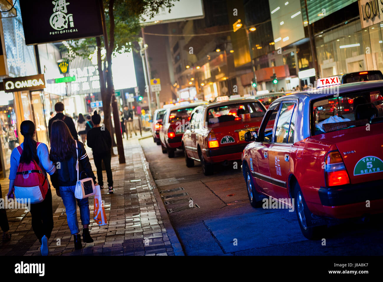 Taxis waiting in line at Tsim Sha Tsui, Hong Kong Stock Photo - Alamy