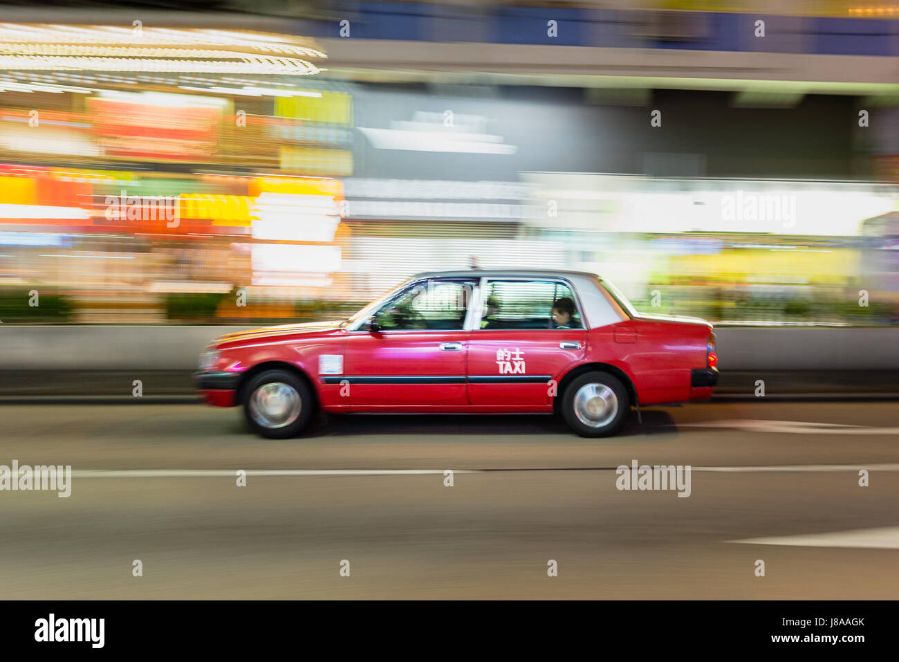 Taxi speeding through Kowloon streets at night Stock Photo - Alamy