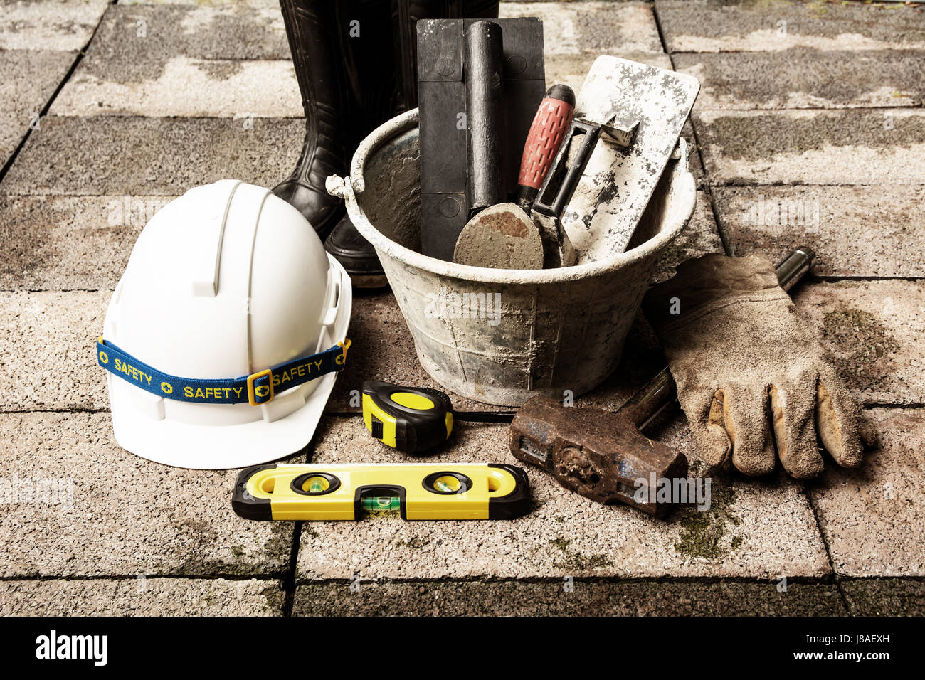 Construction tools or safety equipment with white helmet on brick ...