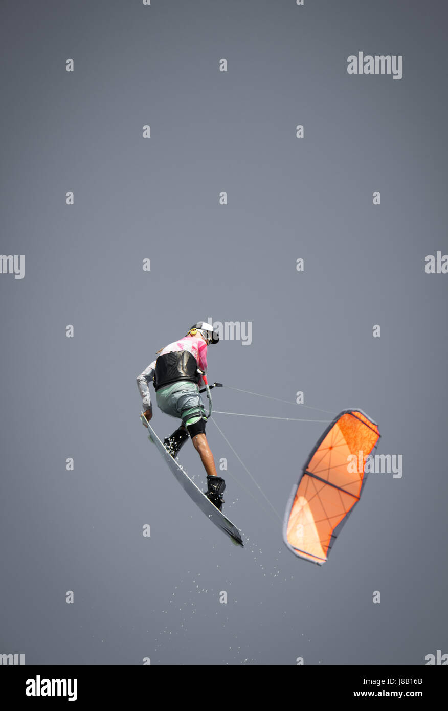 Professional kite boarding rider sportsman with kite in sky jumps high ...