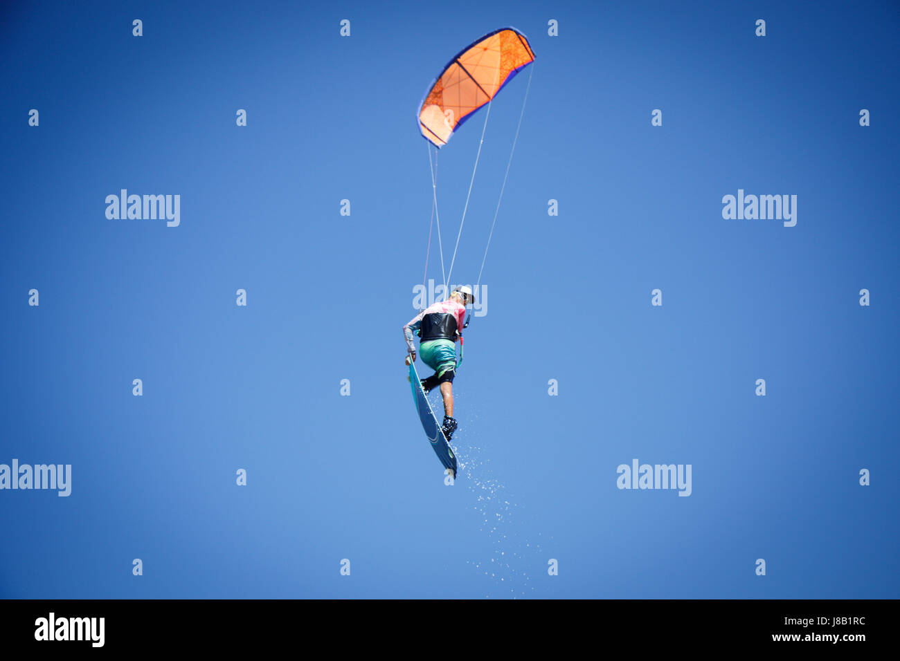 Professional kite boarding rider sportsman with kite in sky jumps high ...