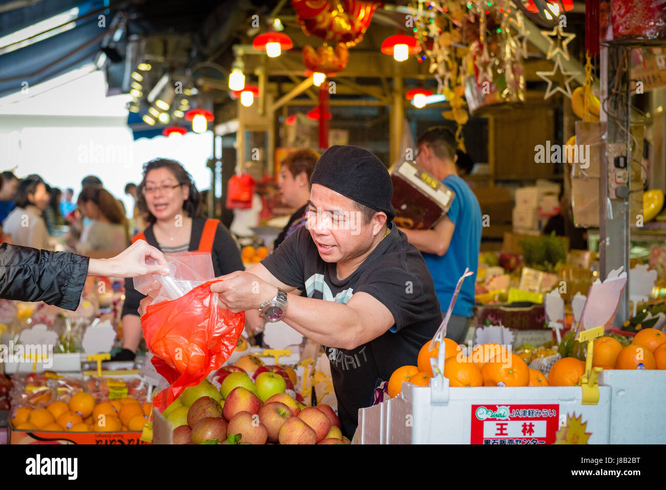 Stallholder at Ya Ma Tei Fruit Market, Hong Kong Stock Photo - Alamy