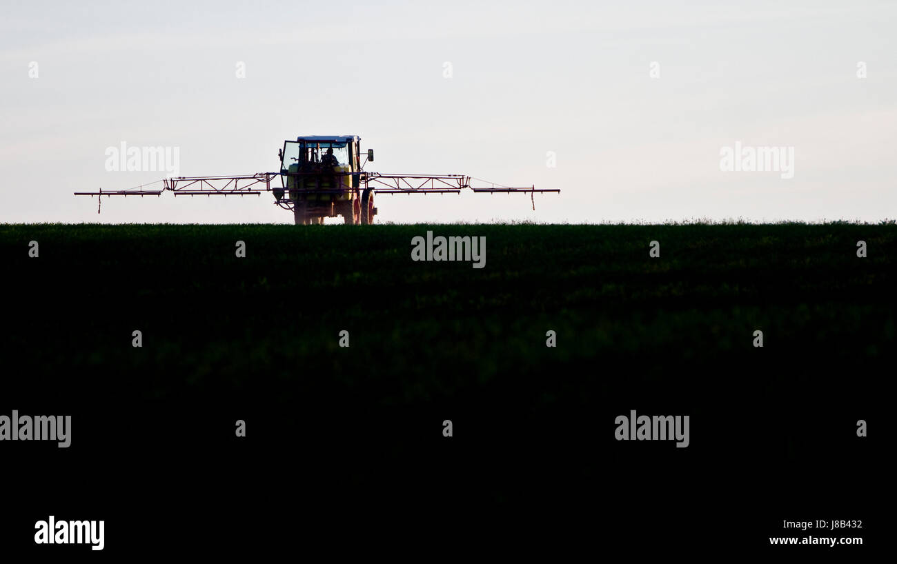 tractor spraying pesticide agriculture Stock Photo - Alamy