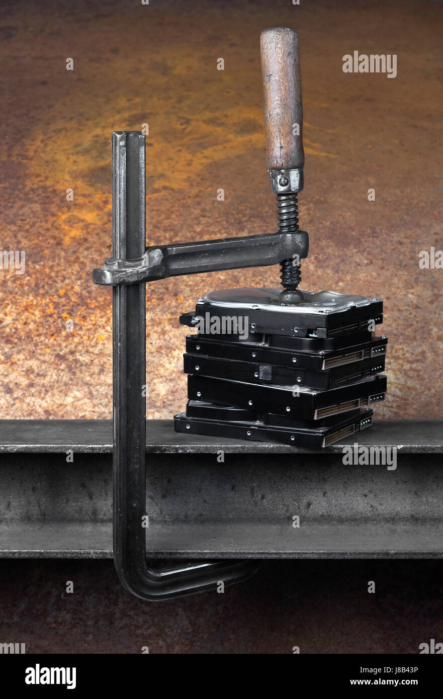 pressing stack of hard drives with a clamp Stock Photo - Alamy