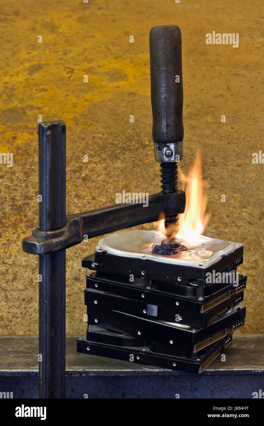 burning stack of hard drive pressed together with clamp Stock Photo - Alamy