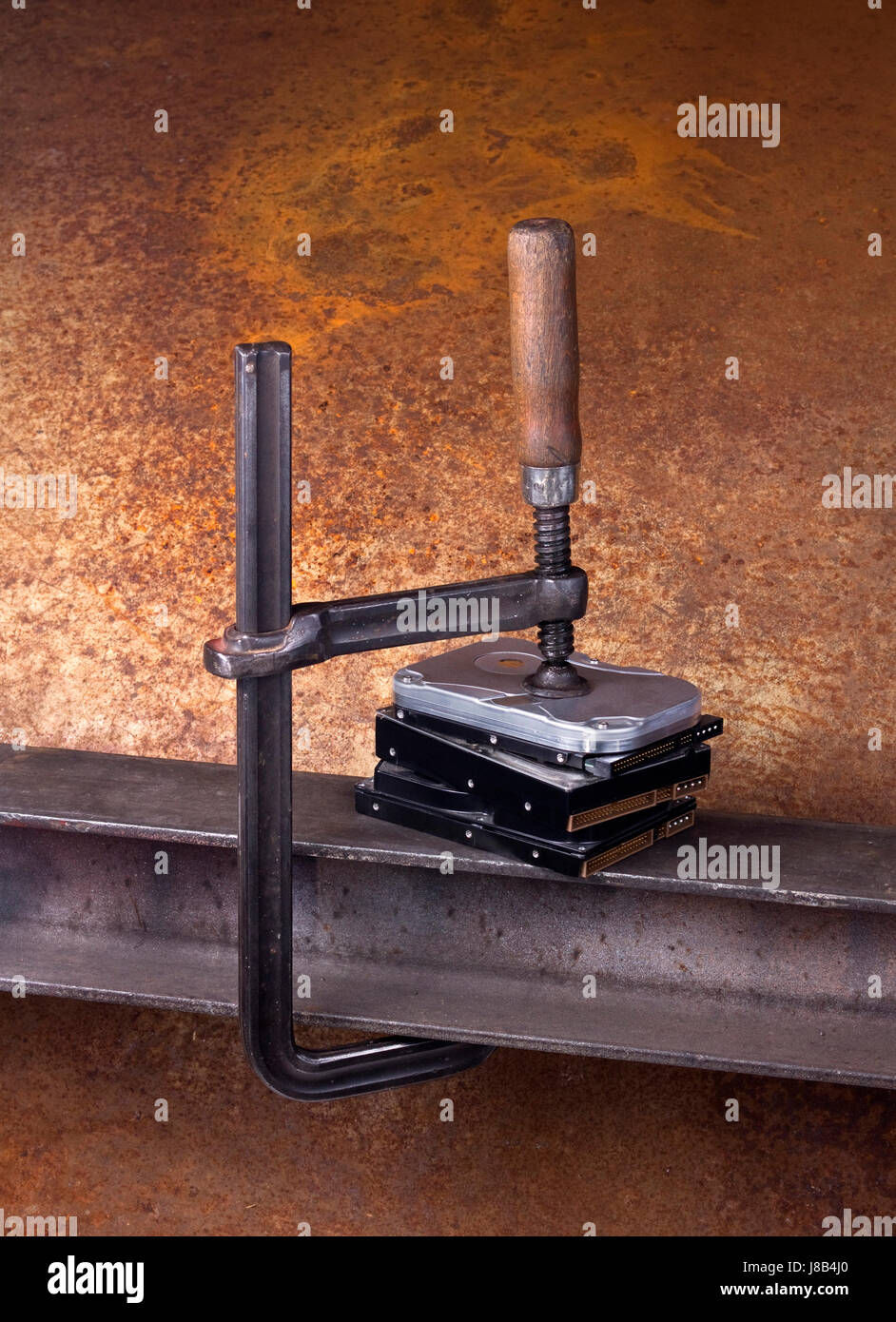 clamp pressing on stack of hard drives Stock Photo - Alamy
